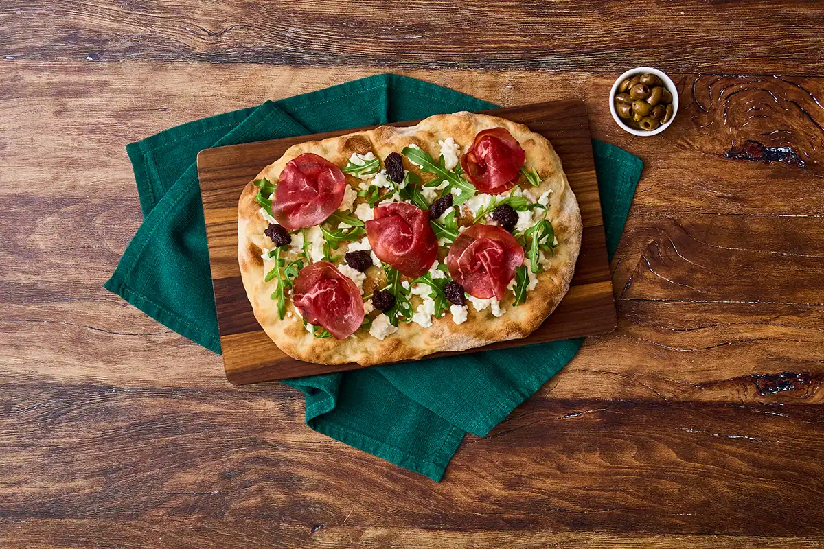 Pinsa con stracchino, bresaola, rucola e paté di olive | Pinsami